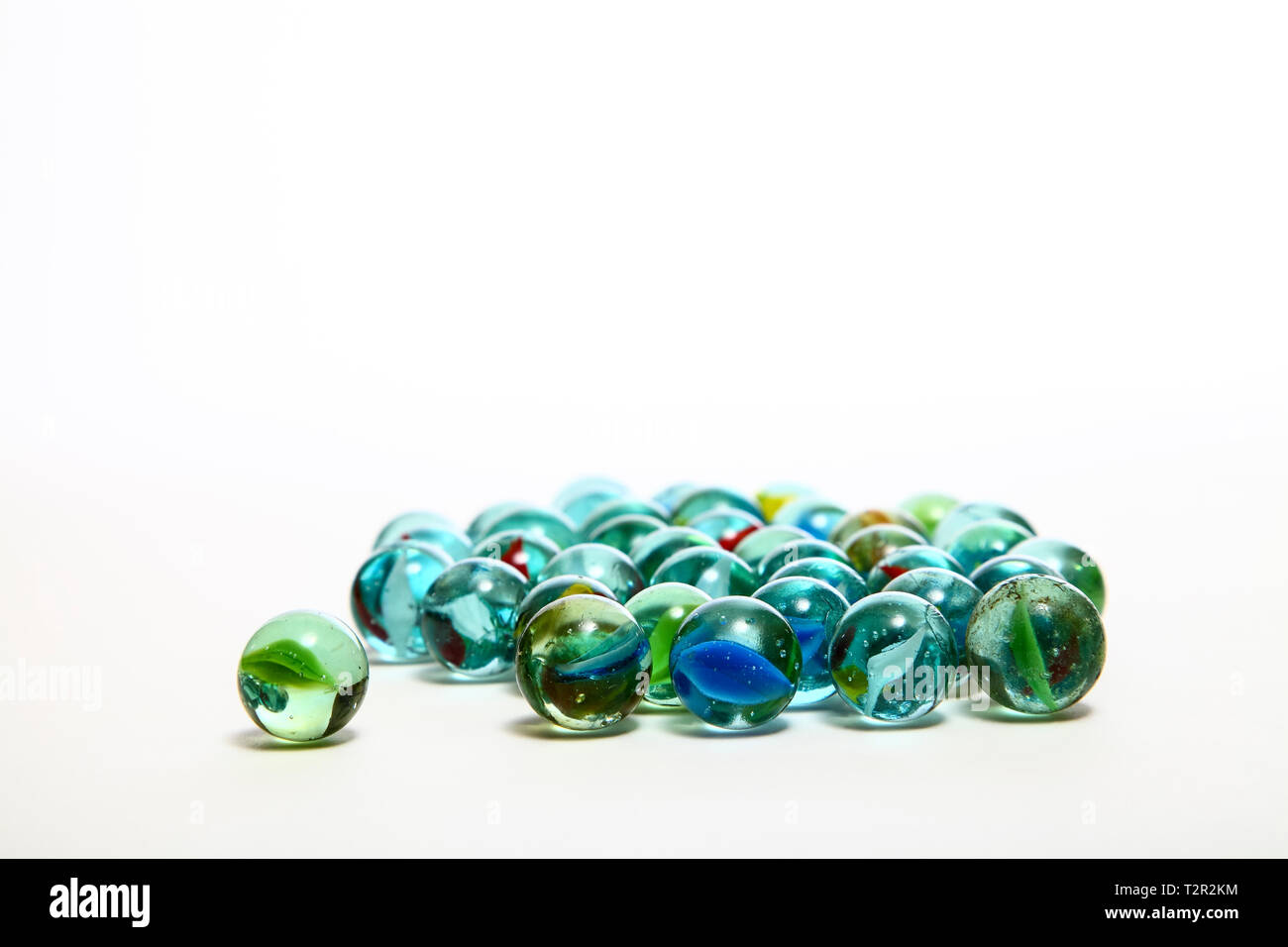 Group of glass marbles isolated on a white background Stock Photo - Alamy