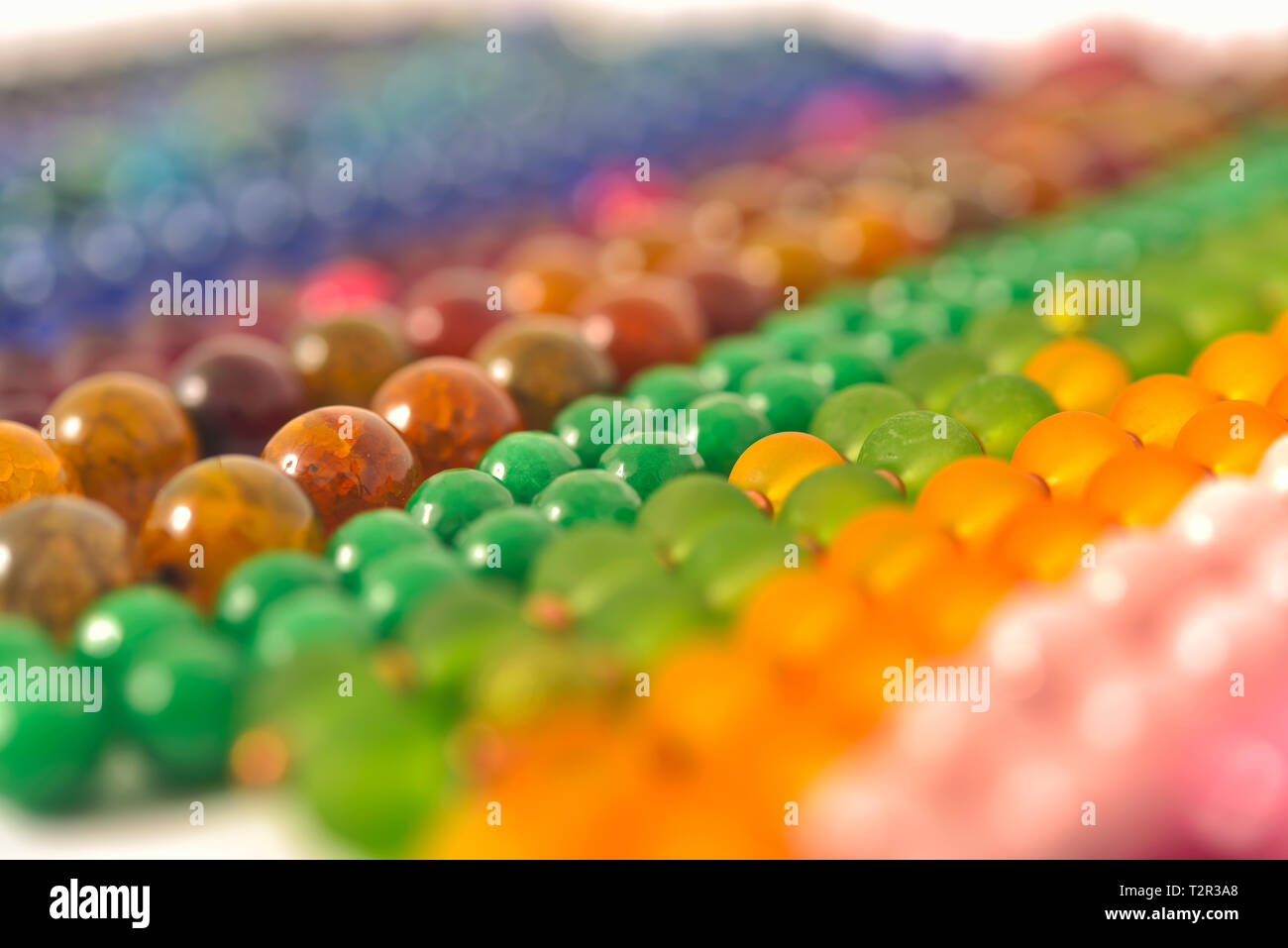 Mixed colors beads close-up made from natural stones or glass marbles ...