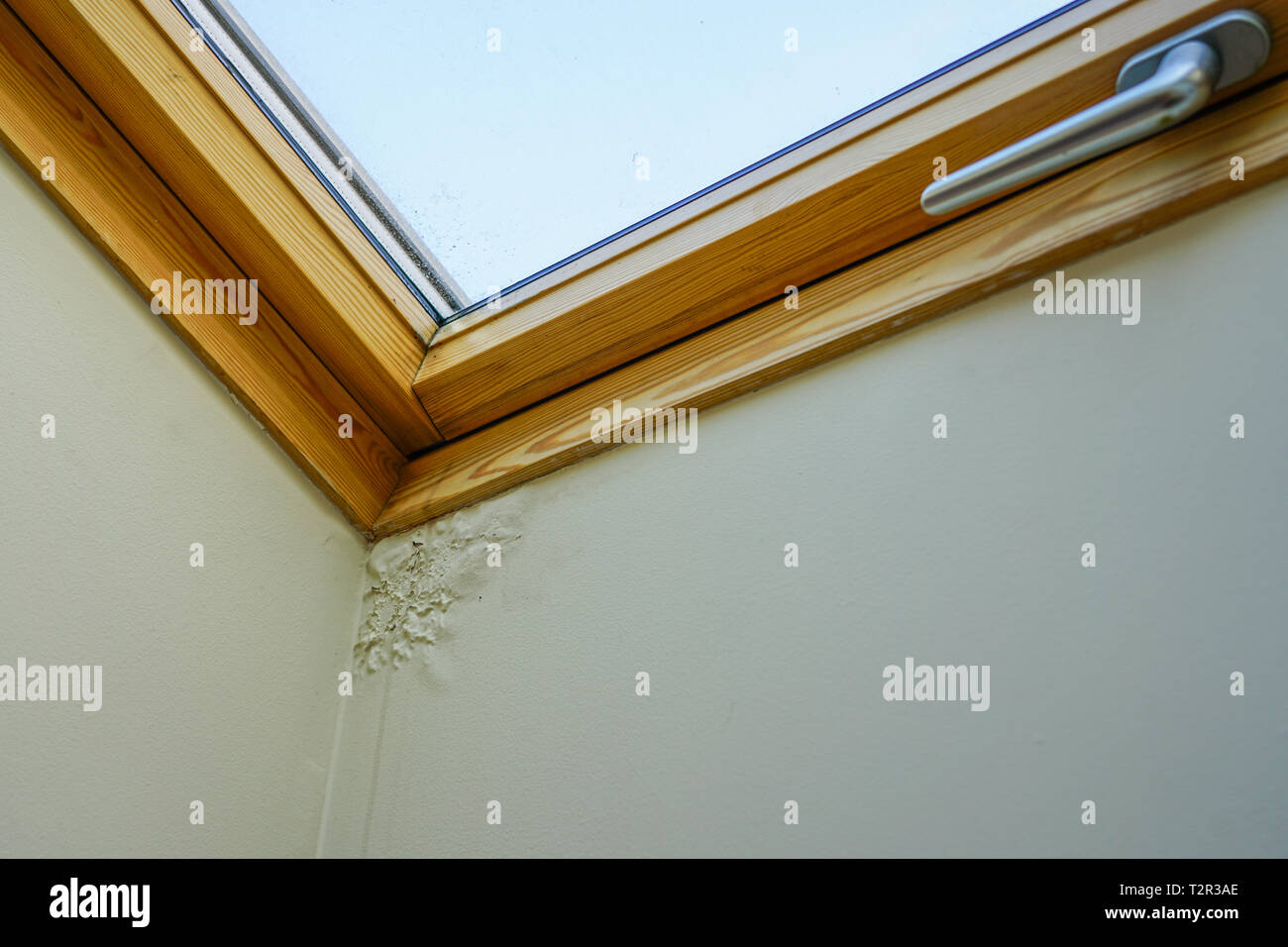 water and moisture damaged ceiling next to wooden roof window Stock ...