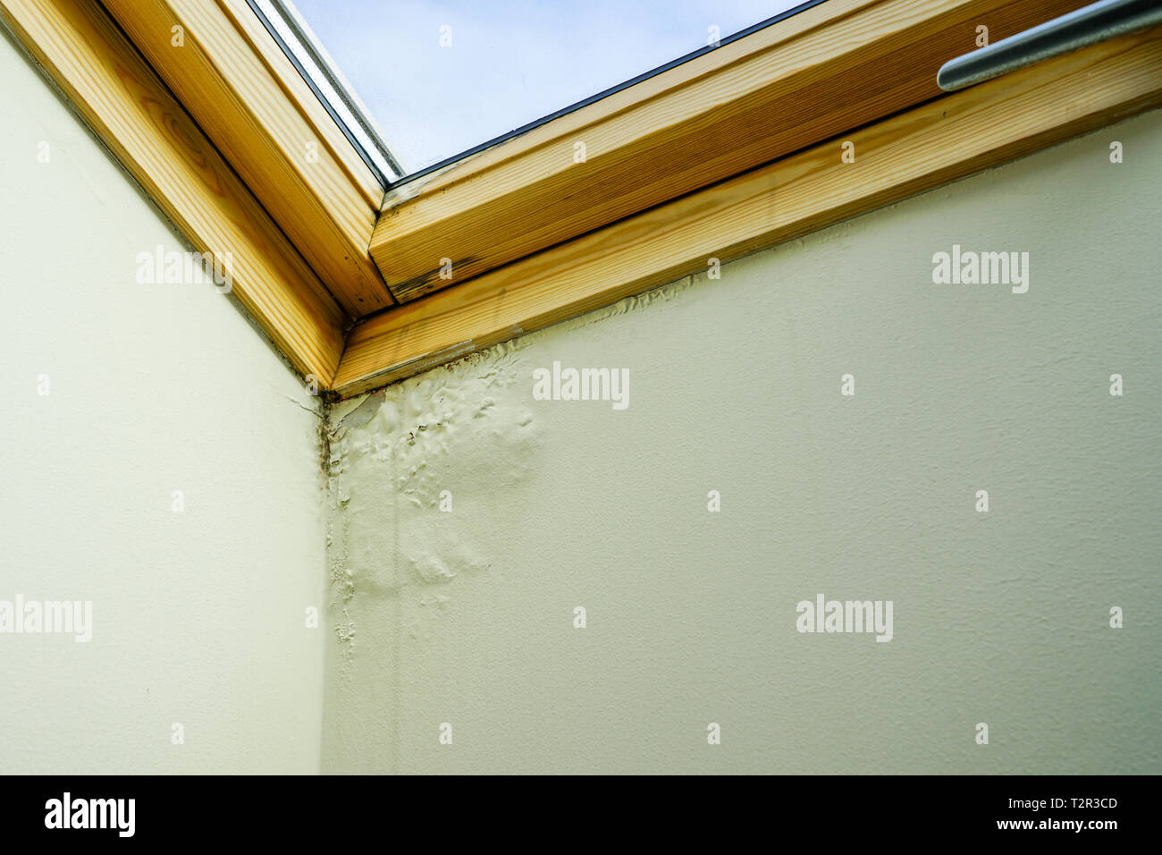 water and moisture damaged ceiling next to wooden roof window Stock ...