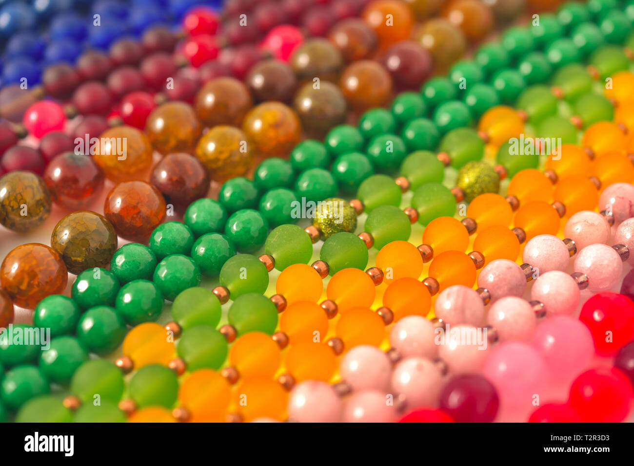 Mixed colors beads close-up made from natural stones or glass marbles ...