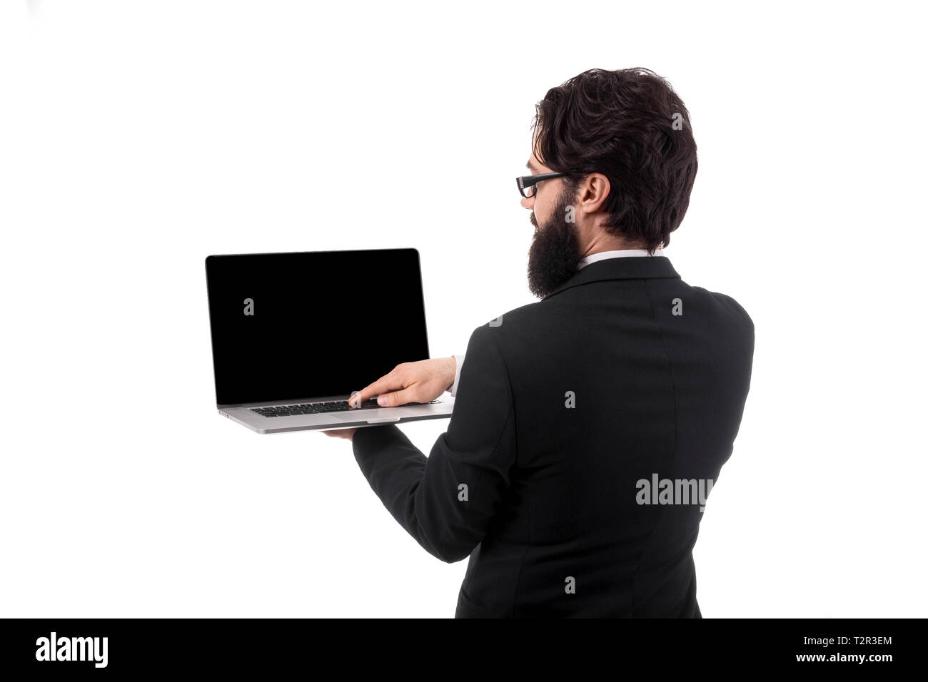 Back view of a standing professional business man holding and using ...