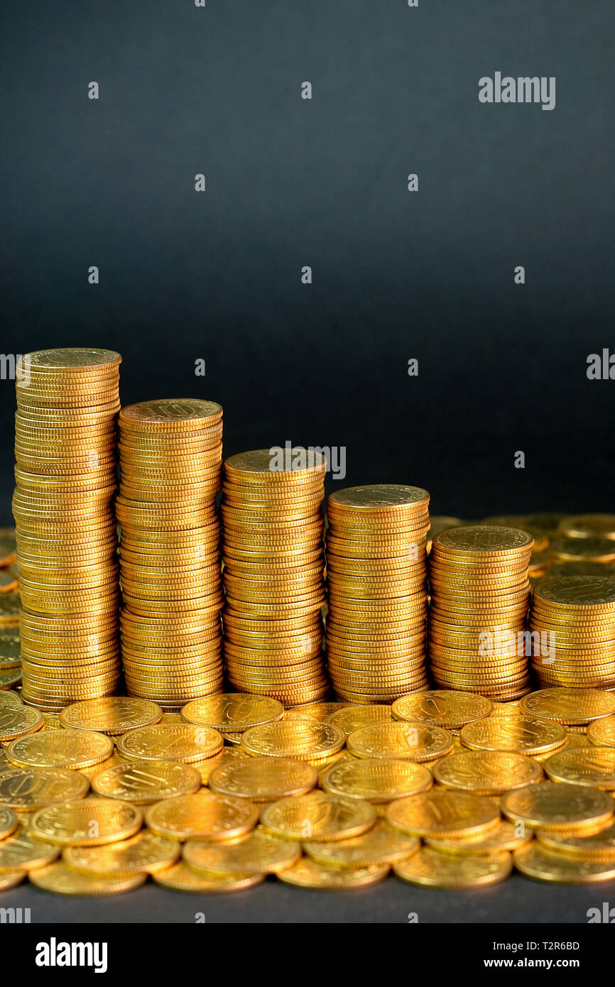 Descending chart made of golden money coins Stock Photo - Alamy