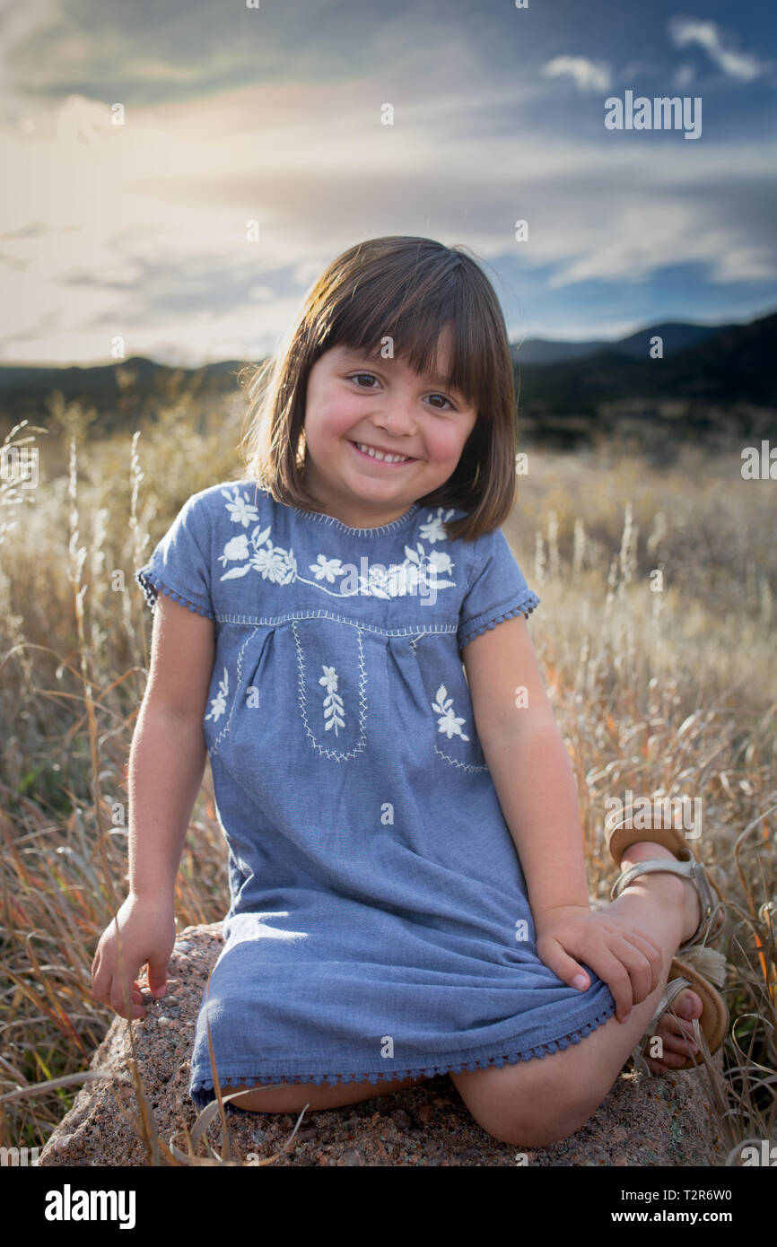 Girl smiling in field Stock Photo - Alamy