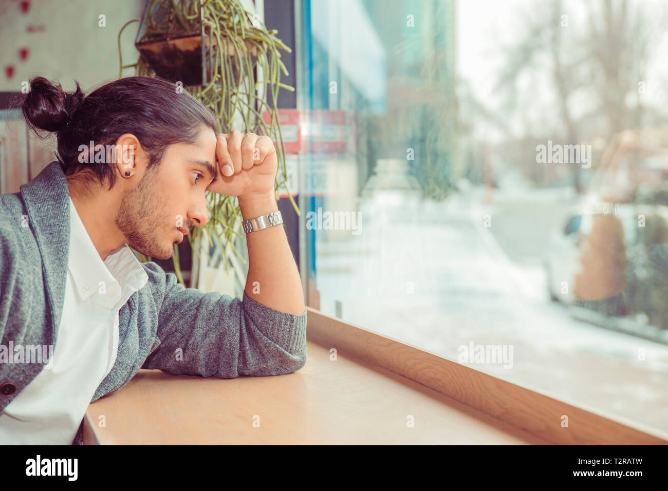Sad young man looking down upset, hand on forehead. Closeup portrait of ...