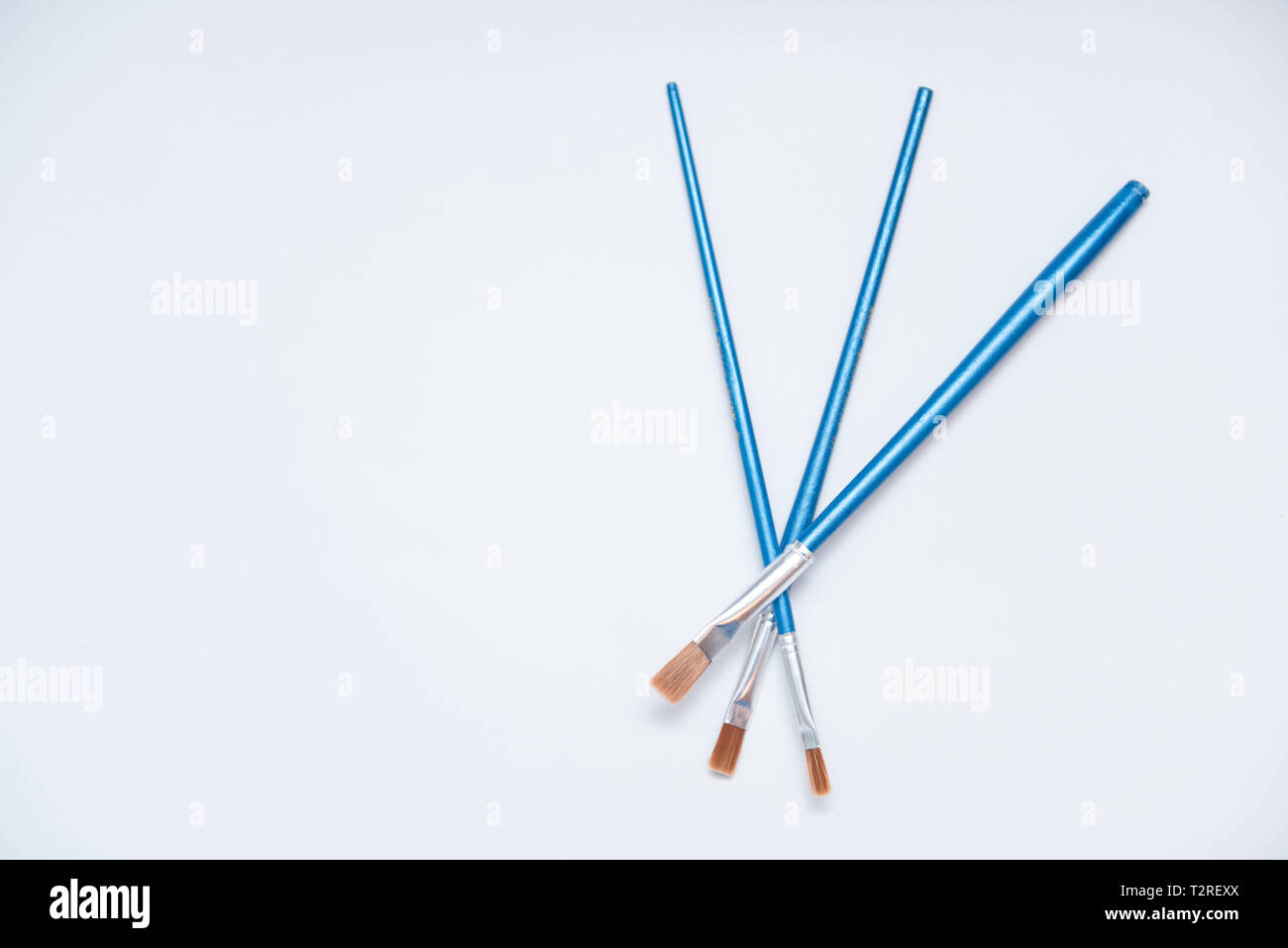 three blue brushes for painting Stock Photo - Alamy