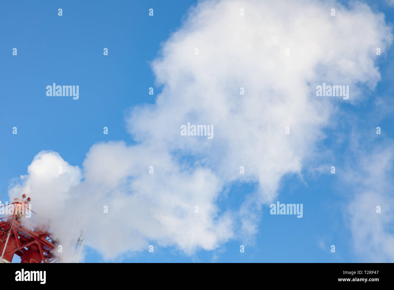 White harmful smoke coming out of the red-and-white pipes with mobile ...