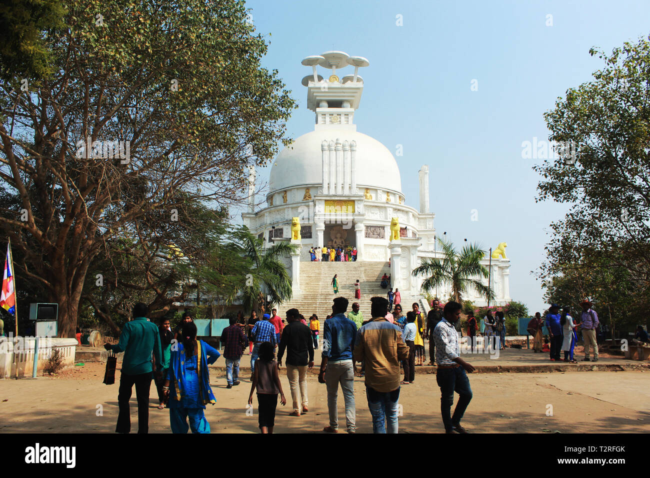visitors enjoying at historical place dhauli temple near daya river ...