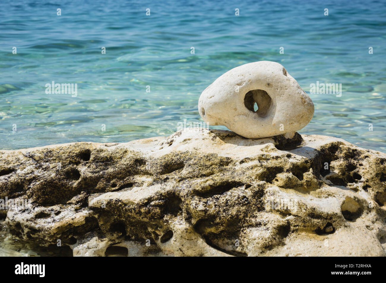 Clear sea and big stone in shape of eye. Wildlife Wunderlast Summer ...
