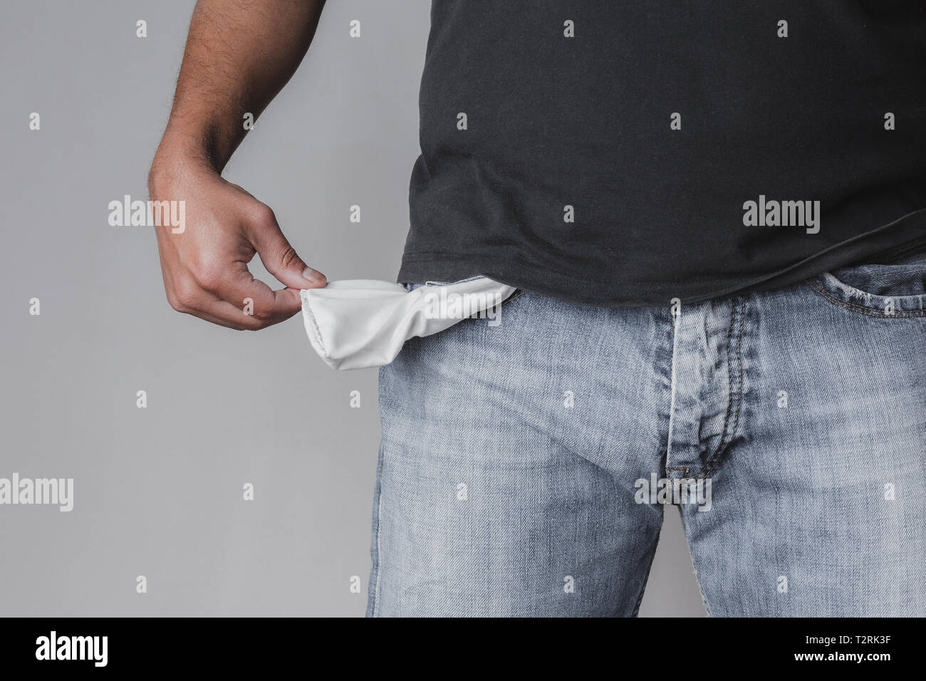 Poor man concept with adult caucausian male showing his empty pockets ...
