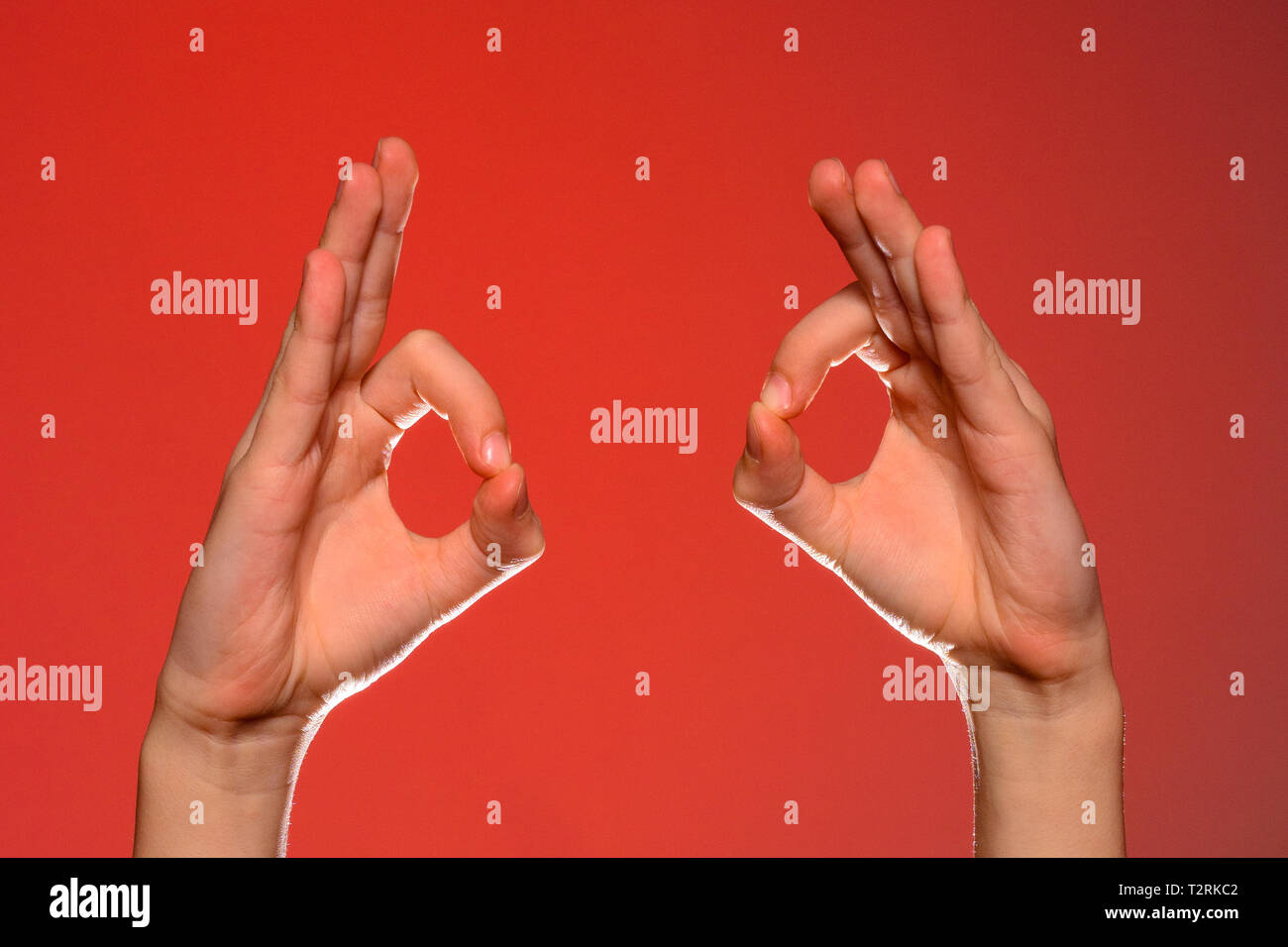 Two human hands show a sign ok, isolated on a red background 2019 Stock ...