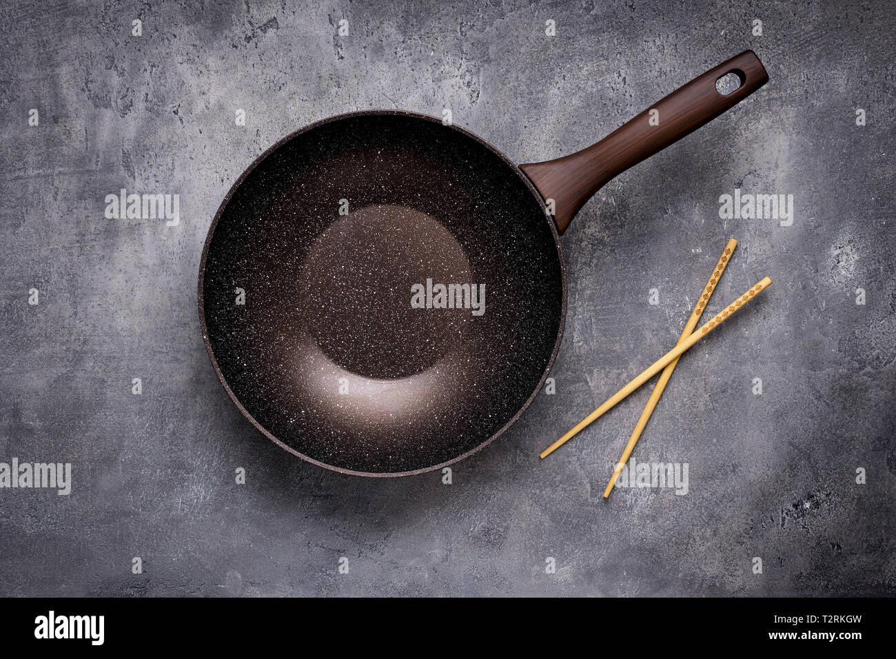 Wok Pan Empty with Wooden Chopsticks on Dark Background. Top View Stock ...