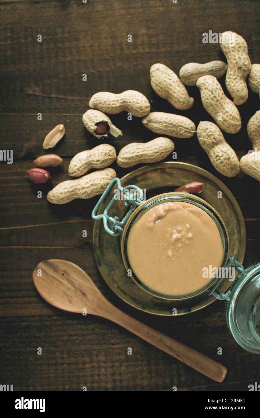Organic Peanut Butter in Glass Jar with Peanuts in Shell on Wooden ...