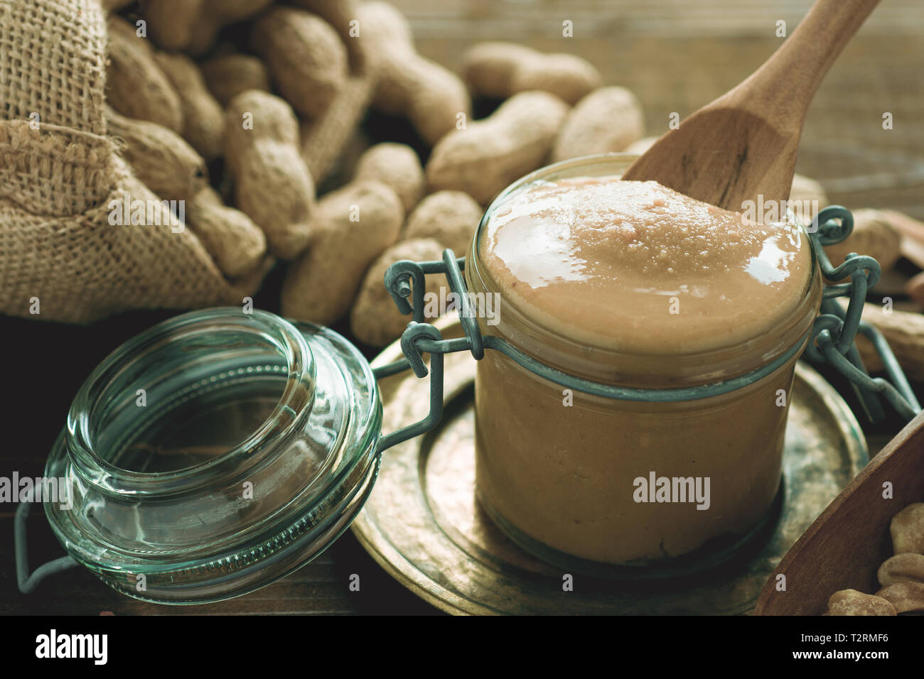 Organic Peanut Butter in Glass Jar with Peanuts in Shell on Wooden ...