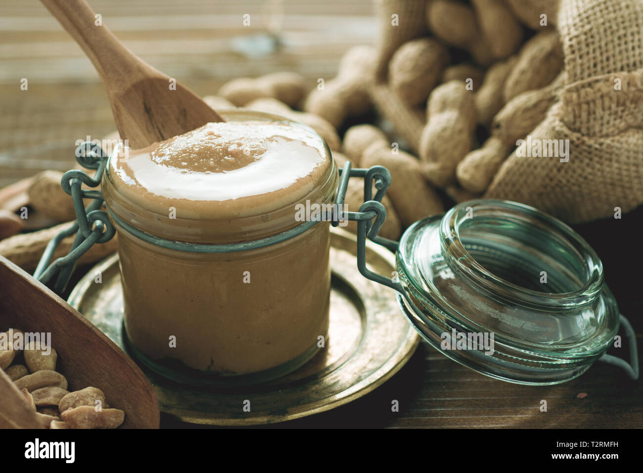 Organic Peanut Butter in Glass Jar with Peanuts in Shell on Wooden ...