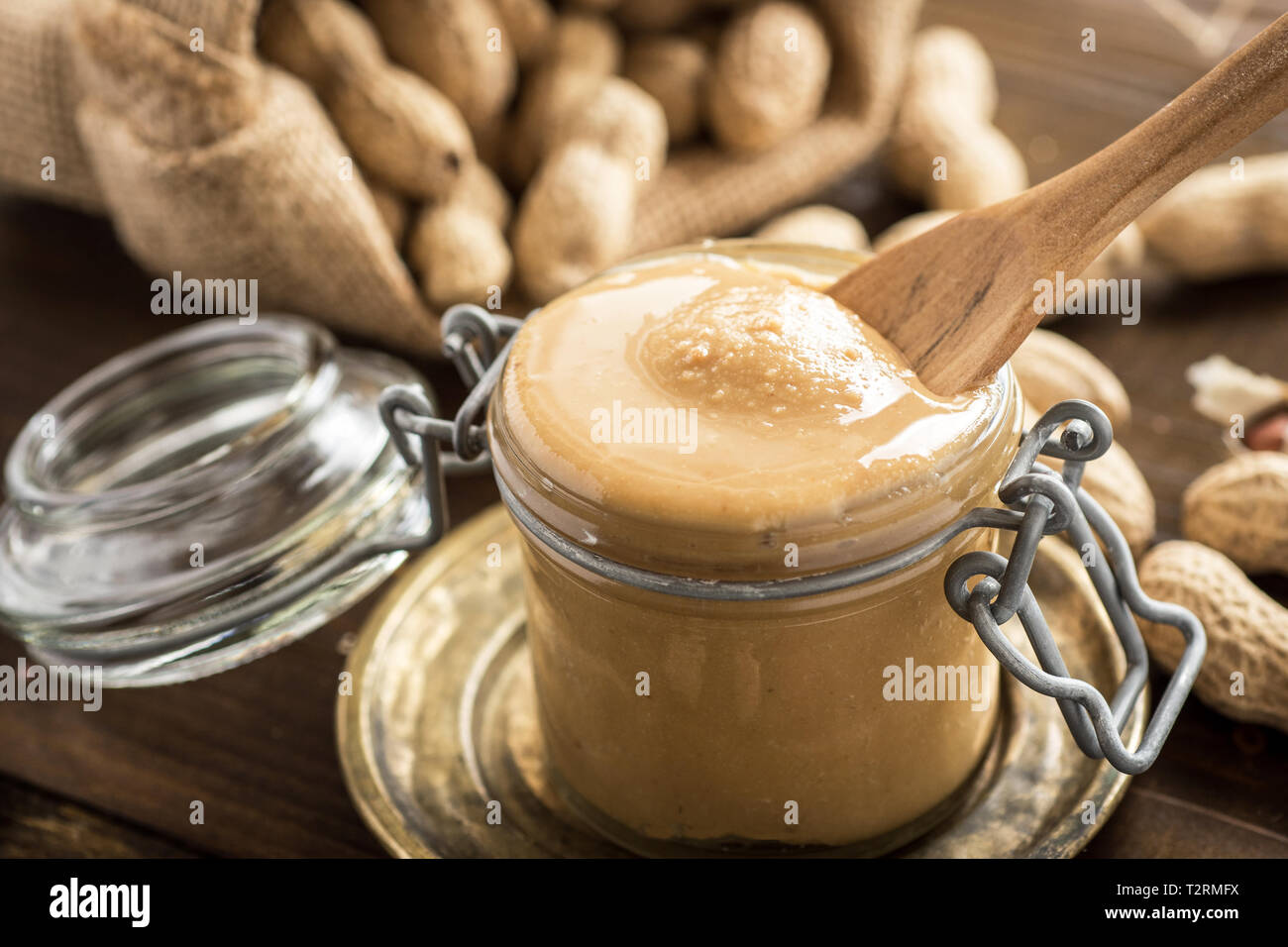 Organic Peanut Butter in Glass Jar with Peanuts in Shell on Wooden ...
