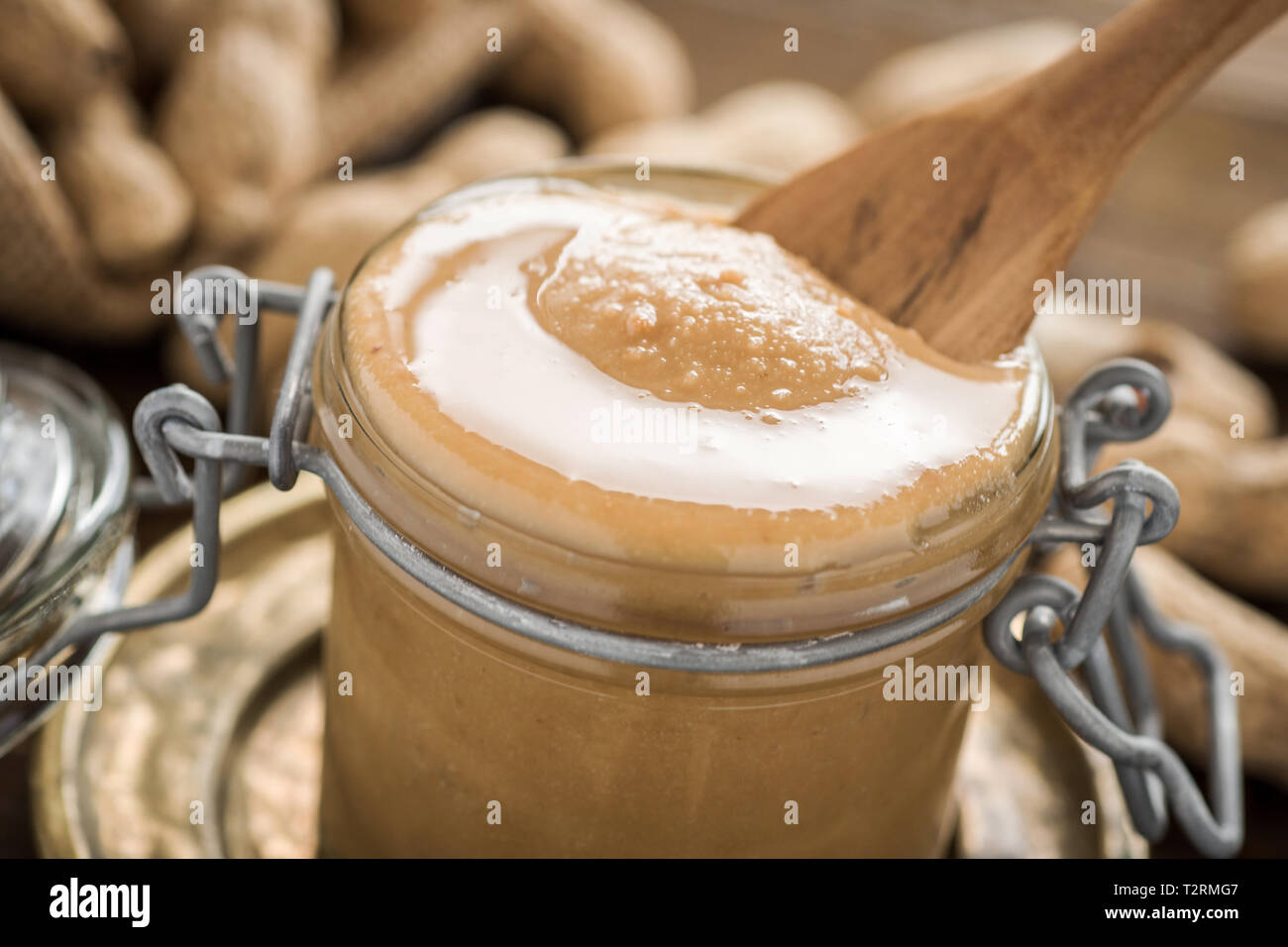 Organic Peanut Butter in Glass Jar with Peanuts in Shell on Wooden ...