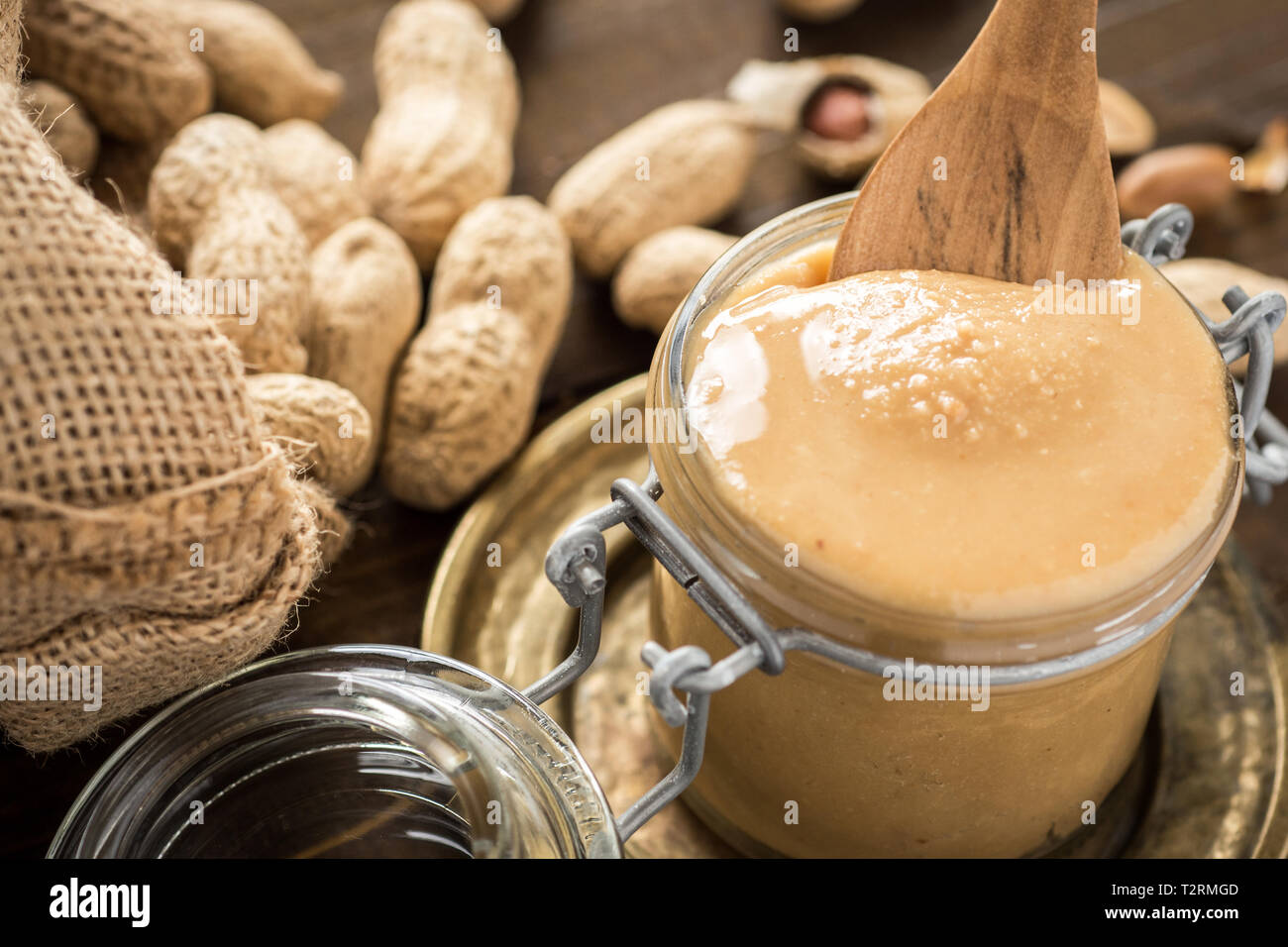 Organic Peanut Butter in Glass Jar with Peanuts in Shell on Wooden ...
