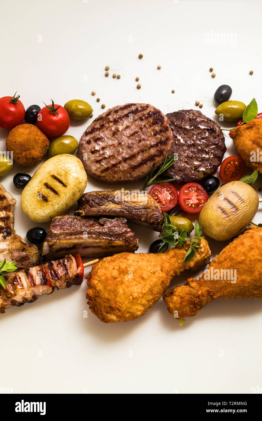 BBQ meat party with different types of meat: beef burgers, pork ribs ...