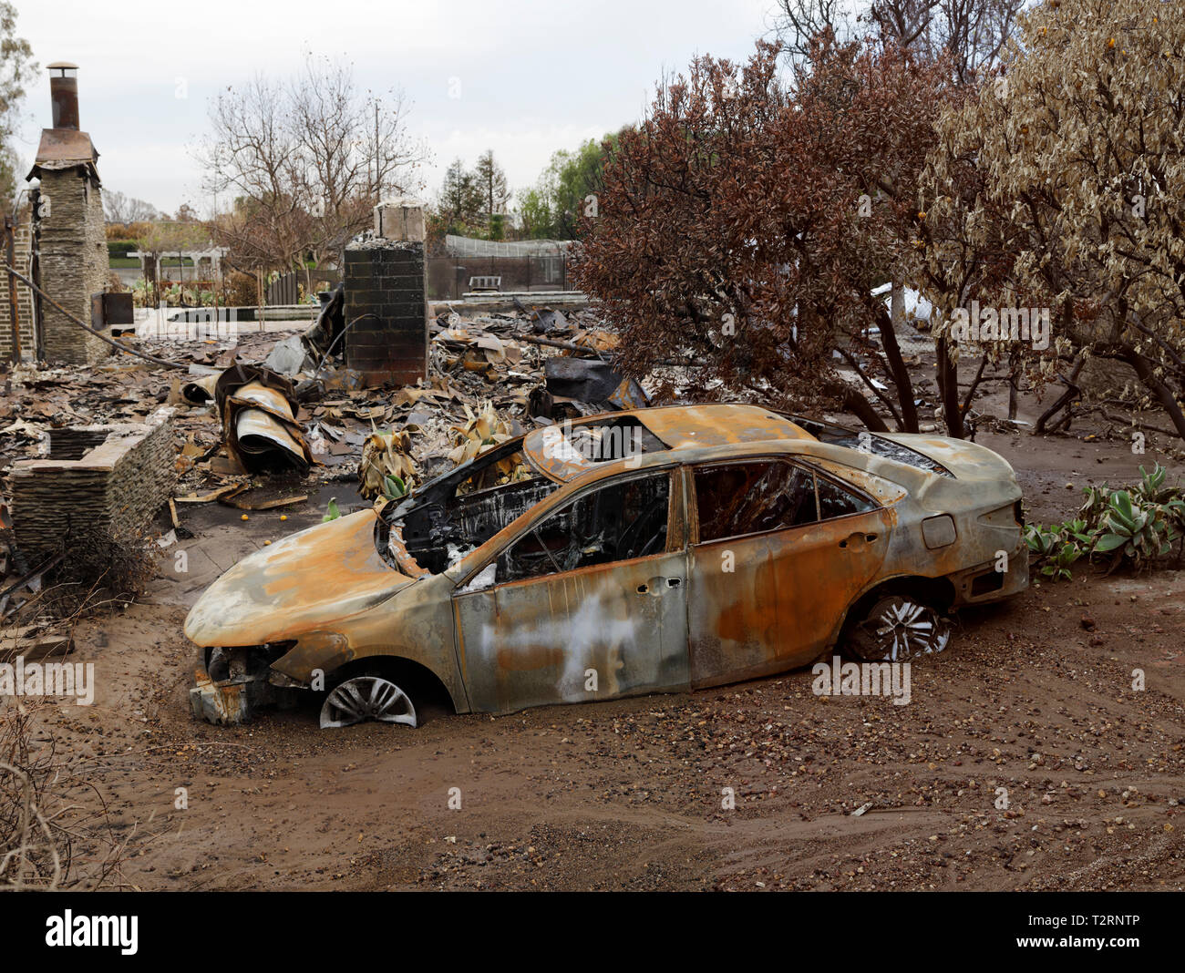Burned down rusty car and burned down house flooded and surround with ...