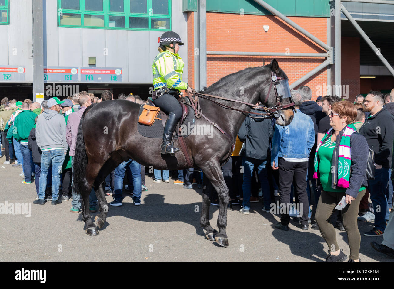 A mounted police officer in Celtic Park directs fans at an old firm ...