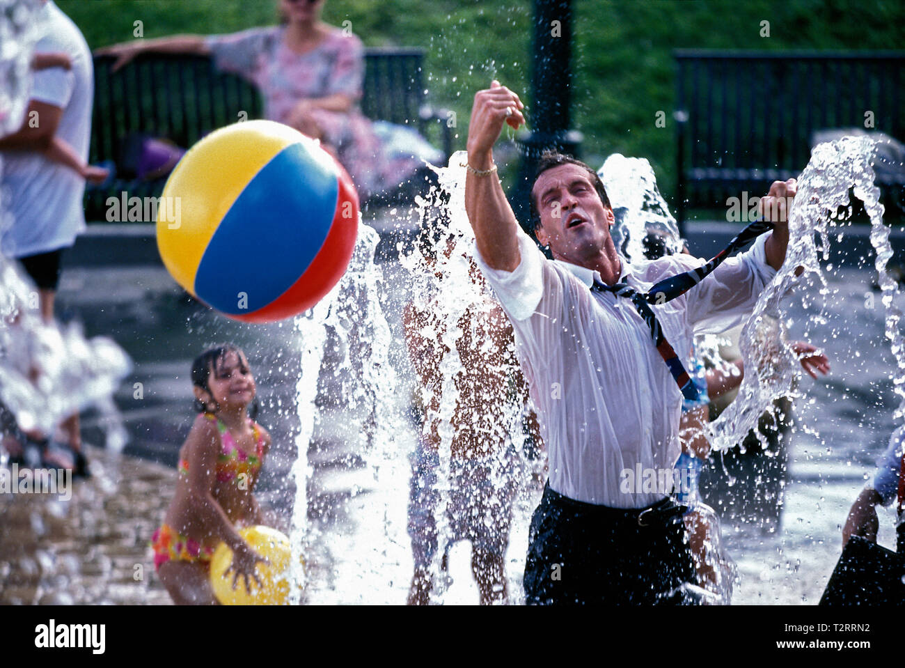 Executive Playing In Water Fountain Stock Photo - Alamy
