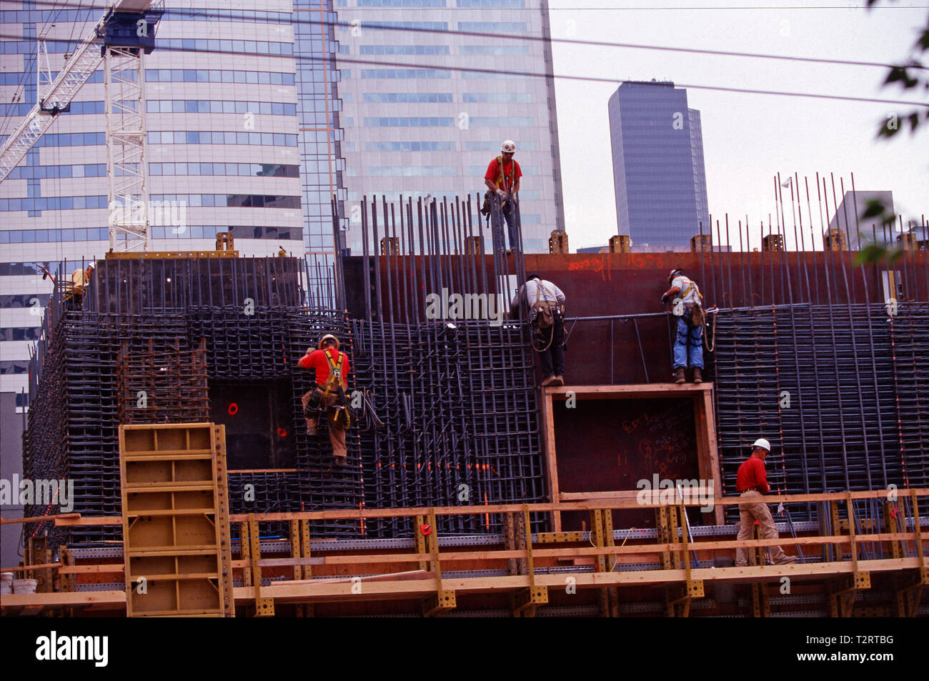 Steel workers working with rebar on new building construction in ...