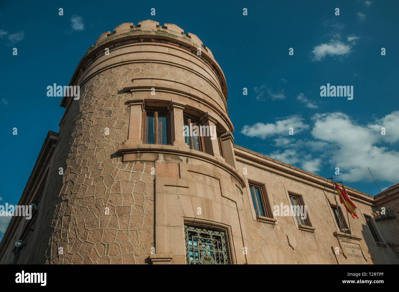 Facade of round gothic building made of stone with large windows at ...