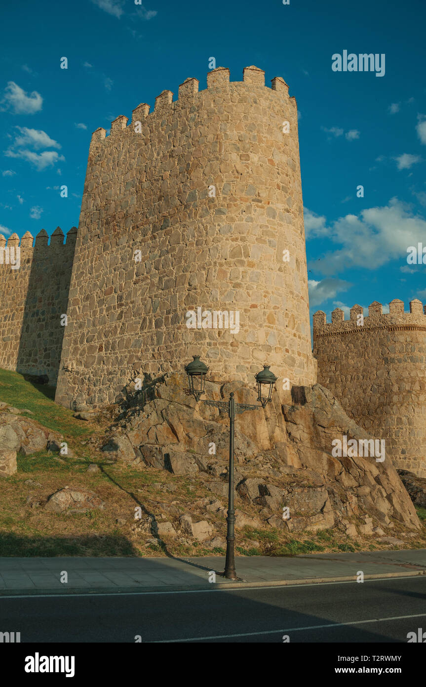 Light post and stone tower over rocky terrain in the large wall of ...
