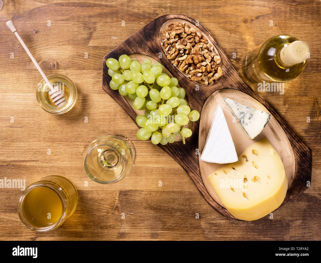 Top view of various cheeses on wooden table in a vintage pub. Fresh ...