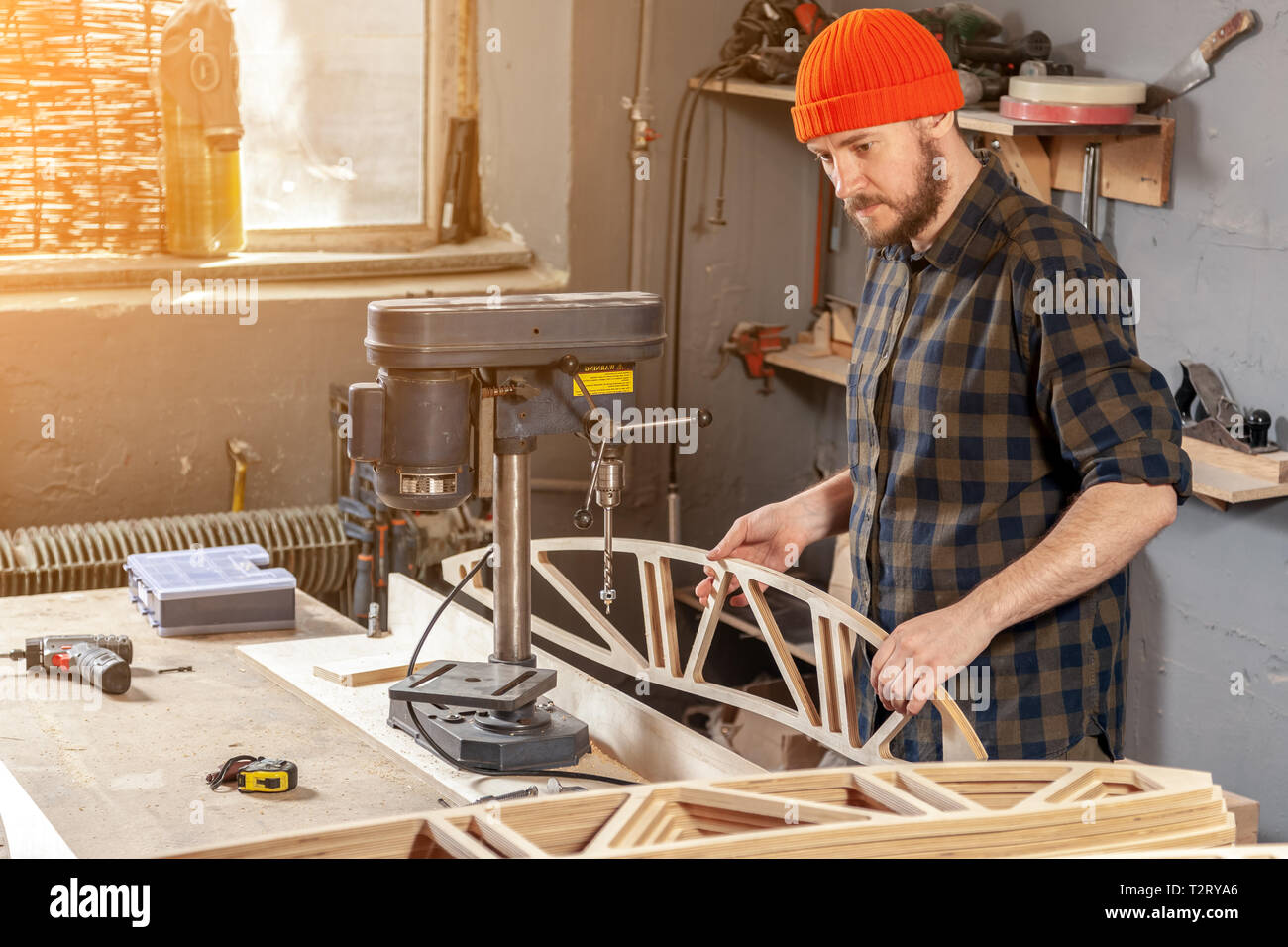 Construction Worker Using Drill To wood. Drill machine on the table in ...