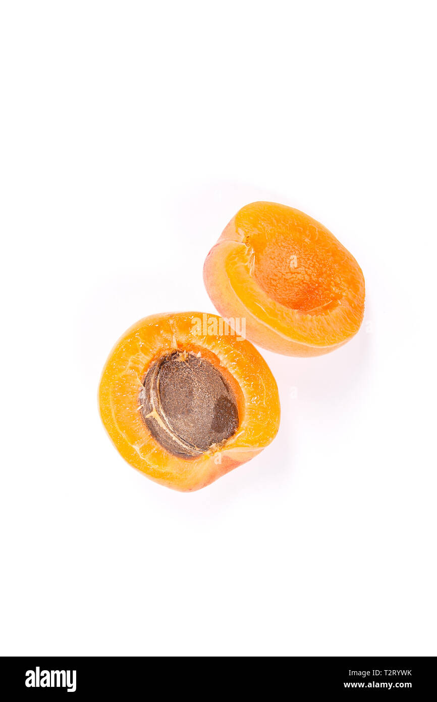 Close up view of ripe whole and halved apricots isolated on white ...