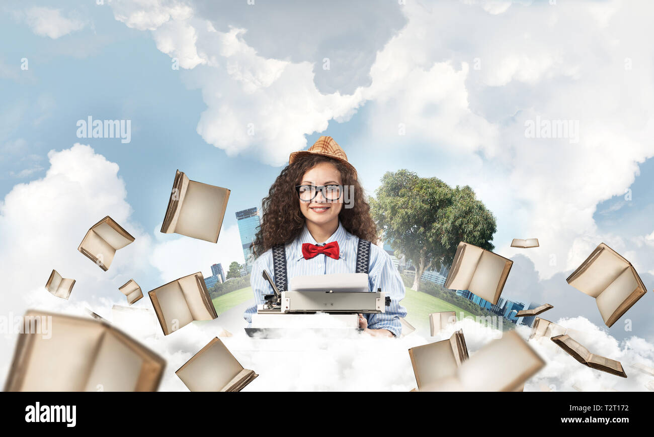 Young and beautiful woman writer in hat and eyeglasses using typing ...