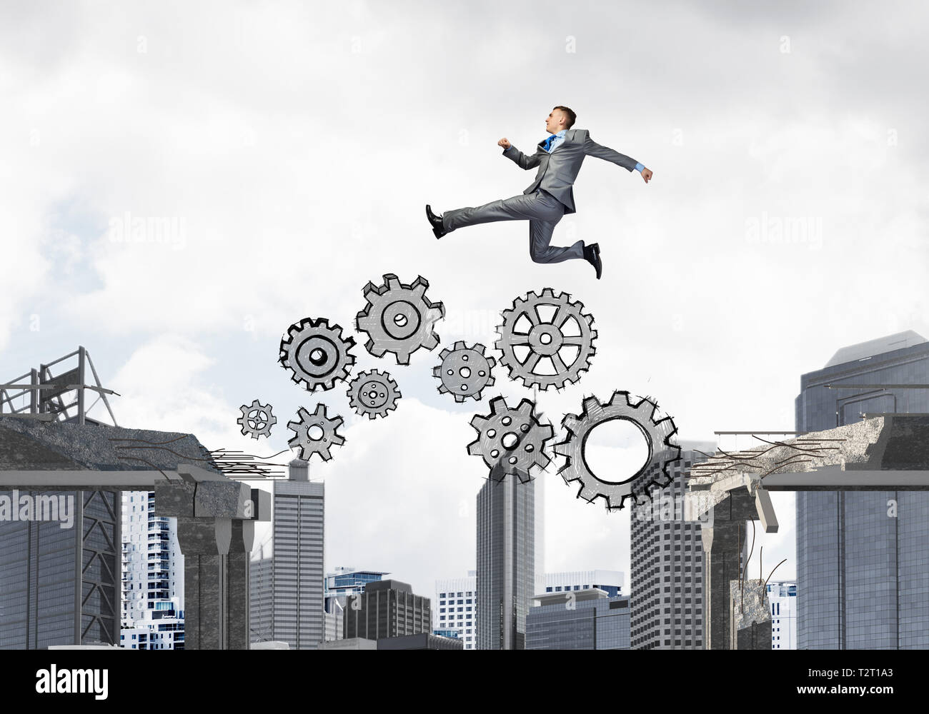 Businessman jumping over gap with gear mechanism in concrete bridge as ...