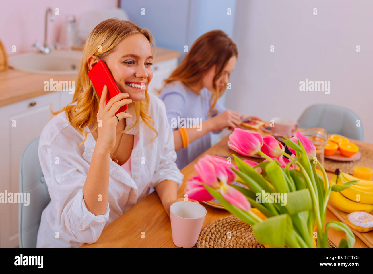 Calling boyfriend. Beautiful blonde-haired young woman calling her ...