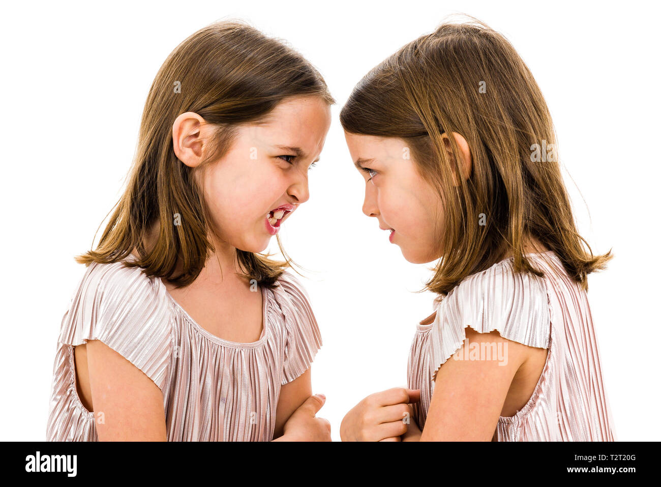 Identical twin girls sisters are arguing yelling at each other. Angry ...