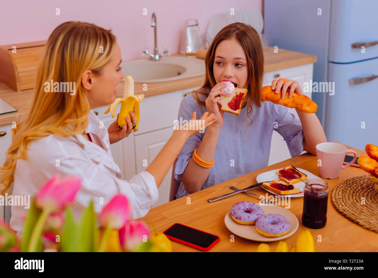 Harm of sweets. Older caring blonde-haired sister telling teenage girl ...