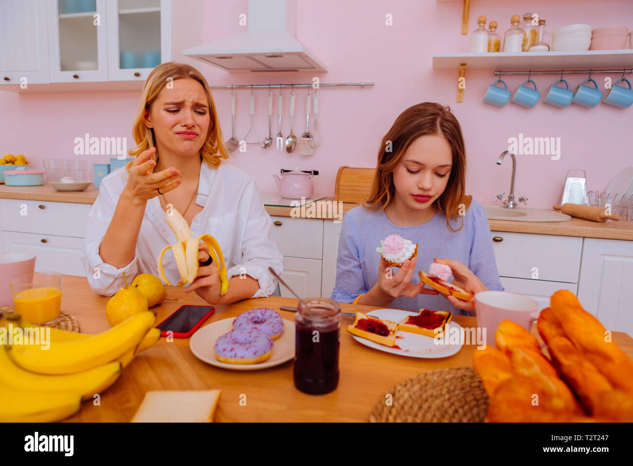 Feeling disguise. Blonde-haired sister having healthy diet feeling ...