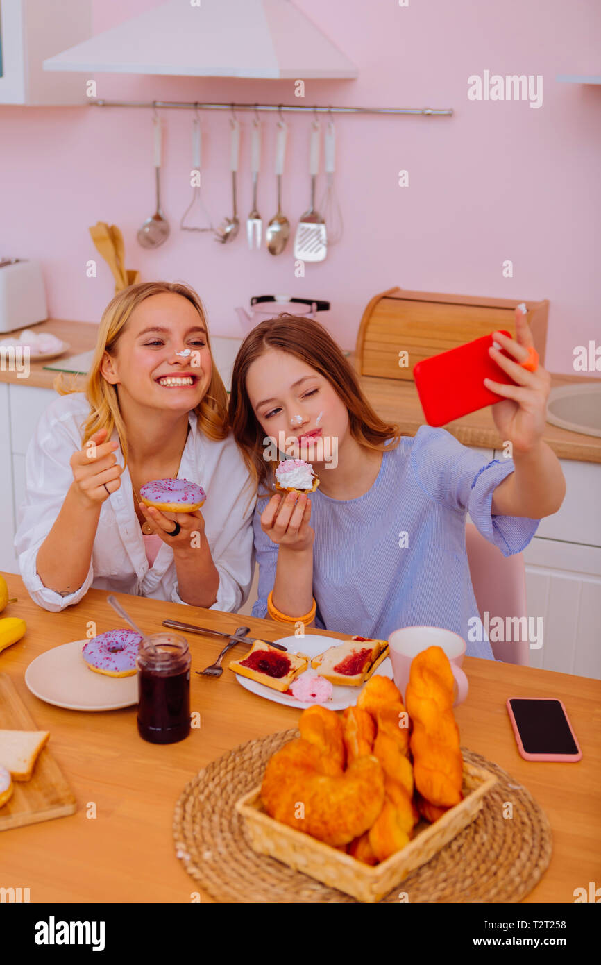 Selfie With Sibling Teenage Girl Holding Red Smartphone While Making