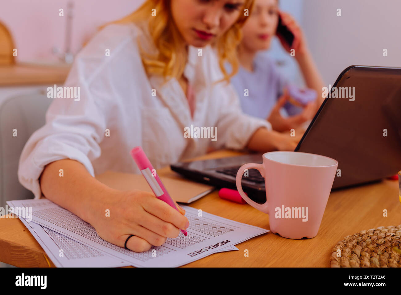 Test for homework. Close up of blonde-haired student doing test for ...