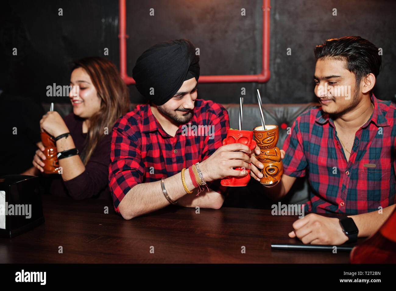 Group of indian friends having fun and rest at night club, drinking ...