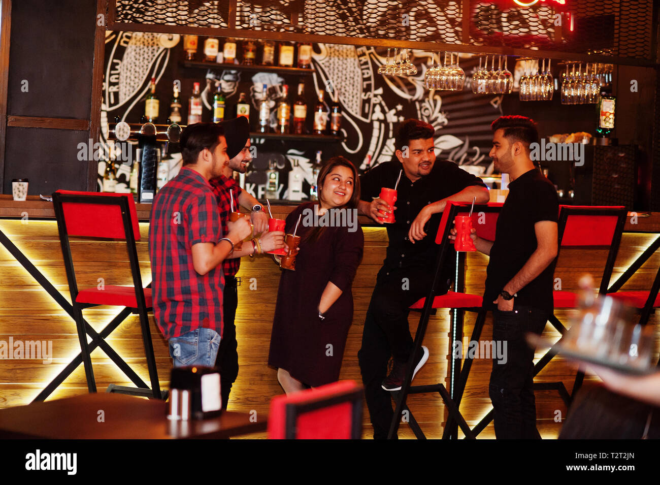 Group of indian friends having fun and rest at night club, drinking ...