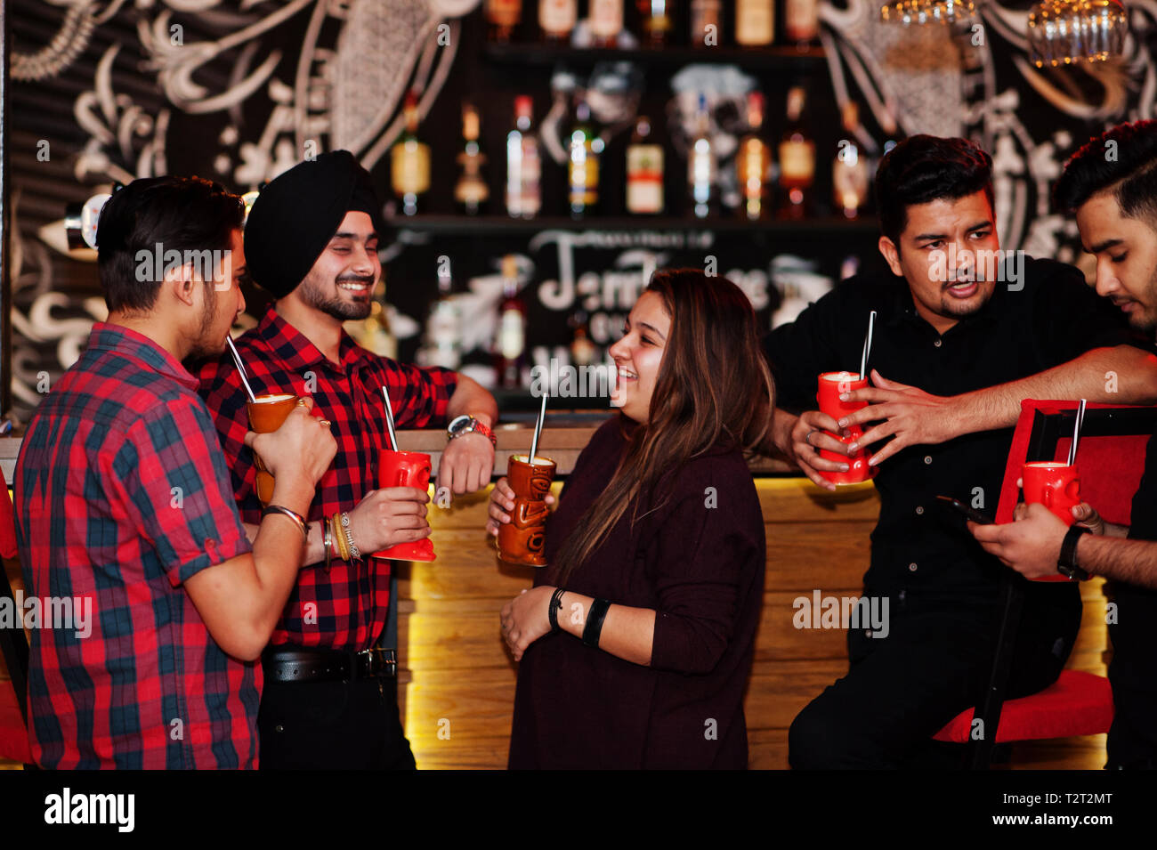 Group of indian friends having fun and rest at night club, drinking ...