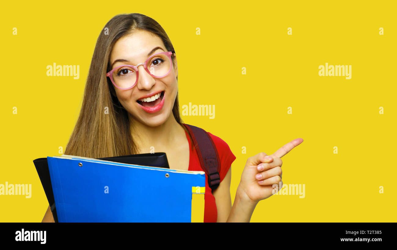 Attractive happy girl being in high spirit after classes, opens mouth ...