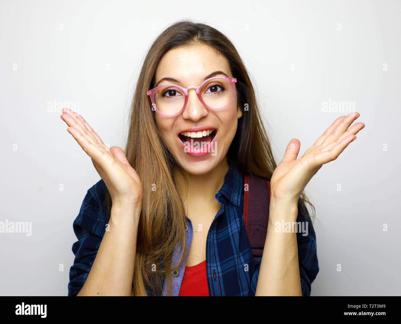 Happy surprised student with glasses looking at the camera on white ...