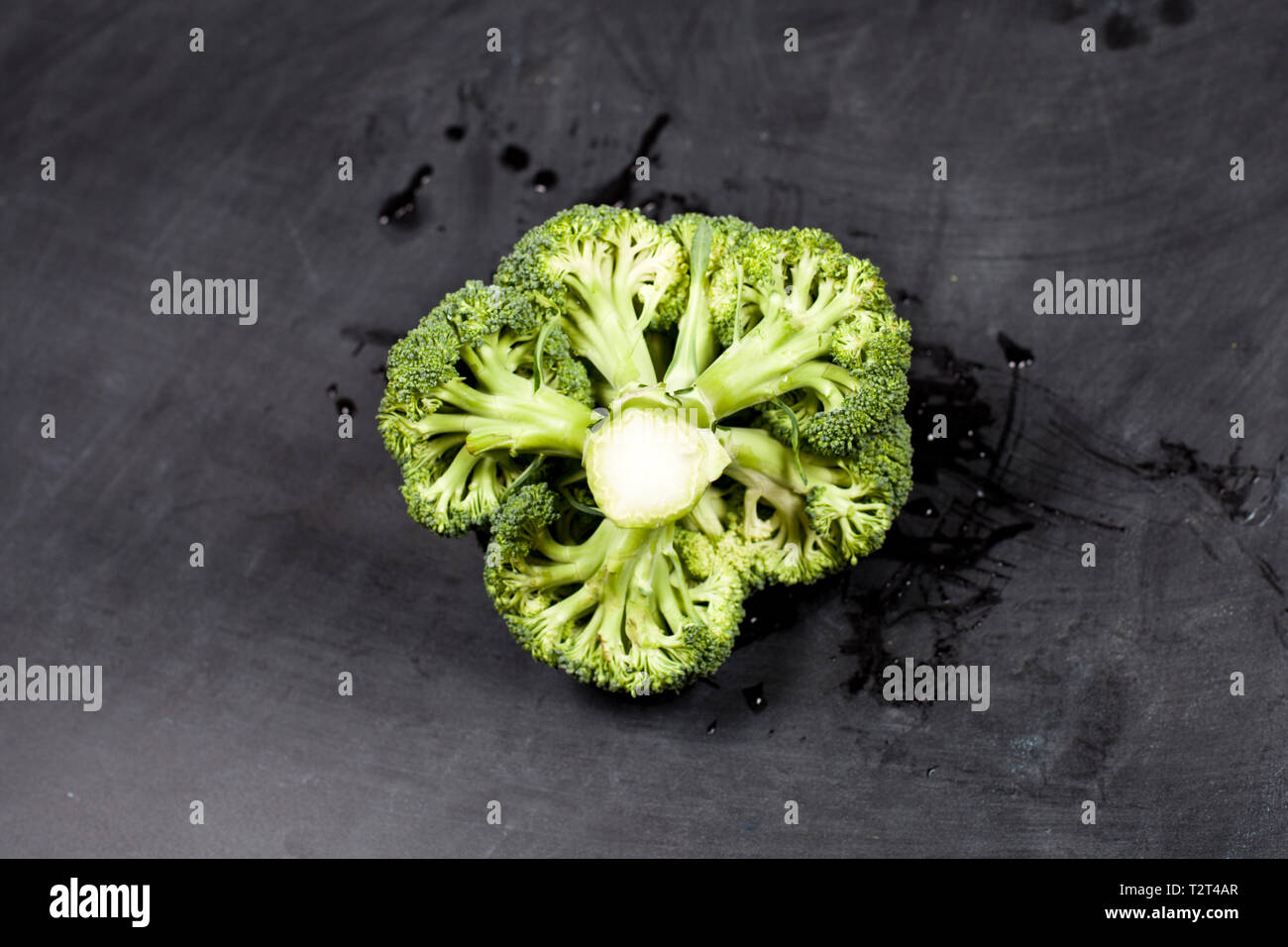 Fresh organic green wet broccoli on black background Stock Photo - Alamy