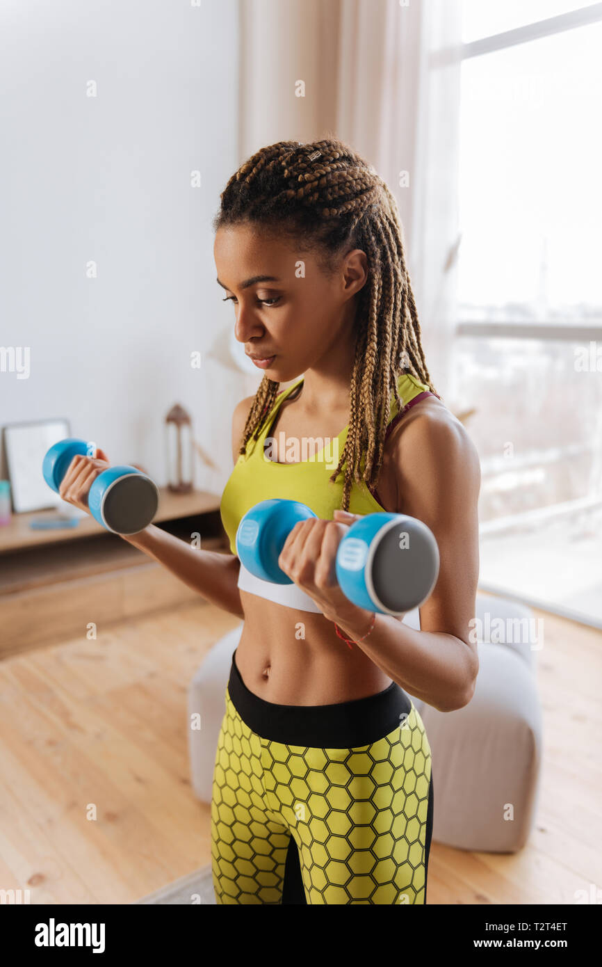 Amazing abs. Fit young woman with nice little braids and amazing abs ...