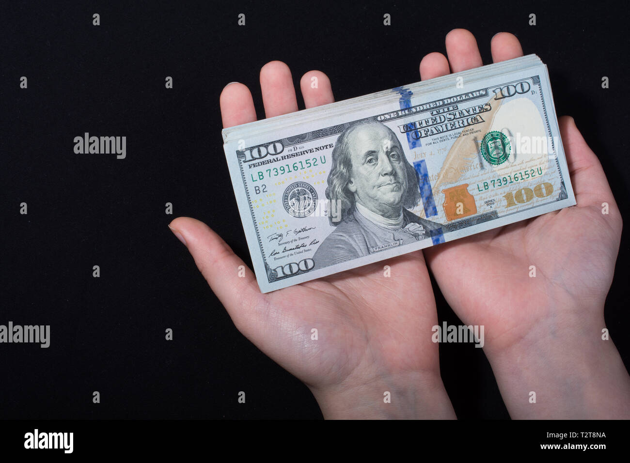 Hand holding American dollar banknotes isolated on white background ...