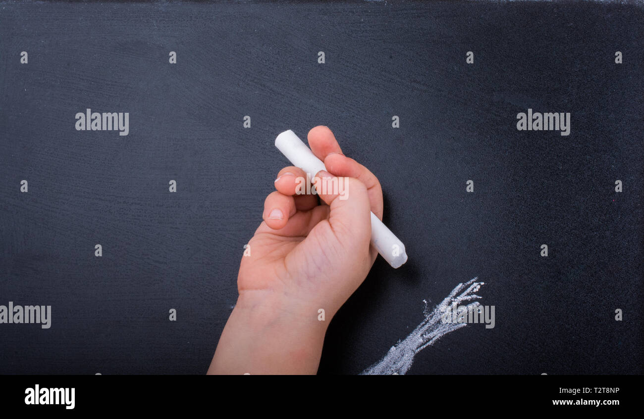 Hand holding white chalk and black board Stock Photo - Alamy