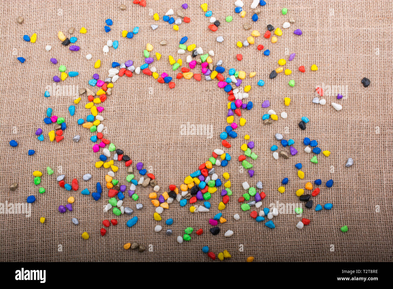 Colorful little pebbles form a heart shape on canvas ground Stock Photo ...